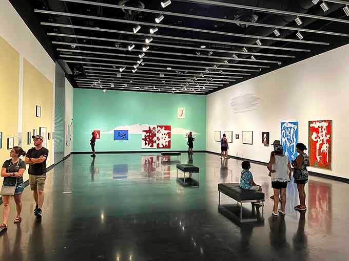 Visitors contemplating modern art in galleries designed to showcase creativity without overwhelming the senses.