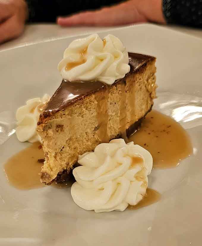 Pumpkin cheesecake with whipped cream that's basically autumn on a plate, minus the raking leaves and questionable weather patterns.