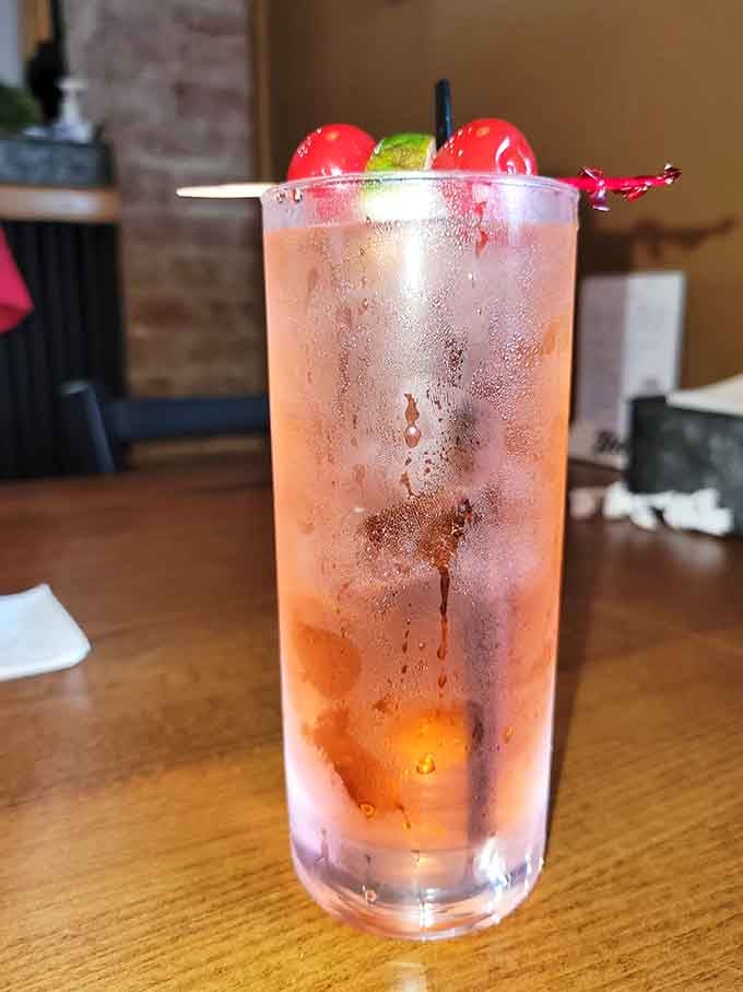 A refreshing beverage garnished with cherries that looks almost too pretty to drink &ndash; almost being the key word.