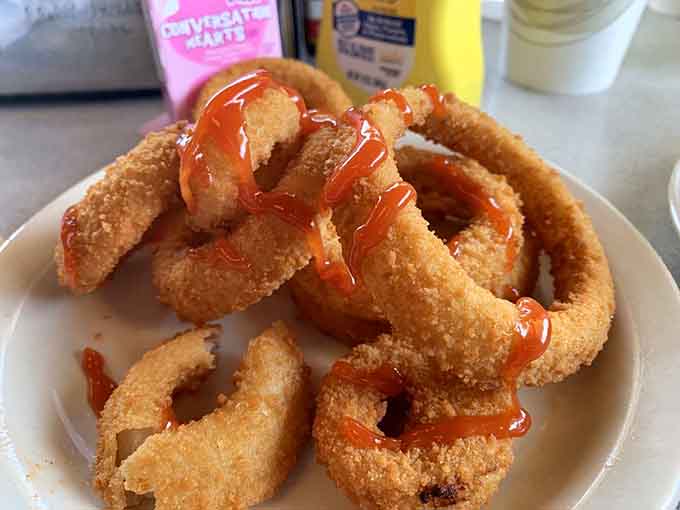 Onion rings with actual onion flavor inside that golden crust, not just fried air pretending to be food.
