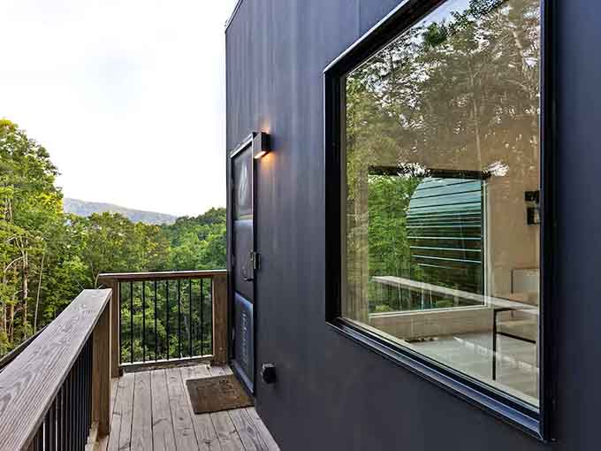 Step onto the wraparound deck where mountain vistas stretch endlessly and your biggest decision is which chair to claim.