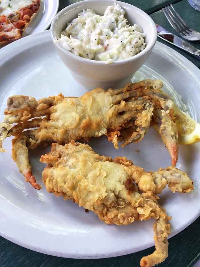Soft shell crabs fried to golden perfection alongside creamy coleslaw make for one spectacular seafood feast here.