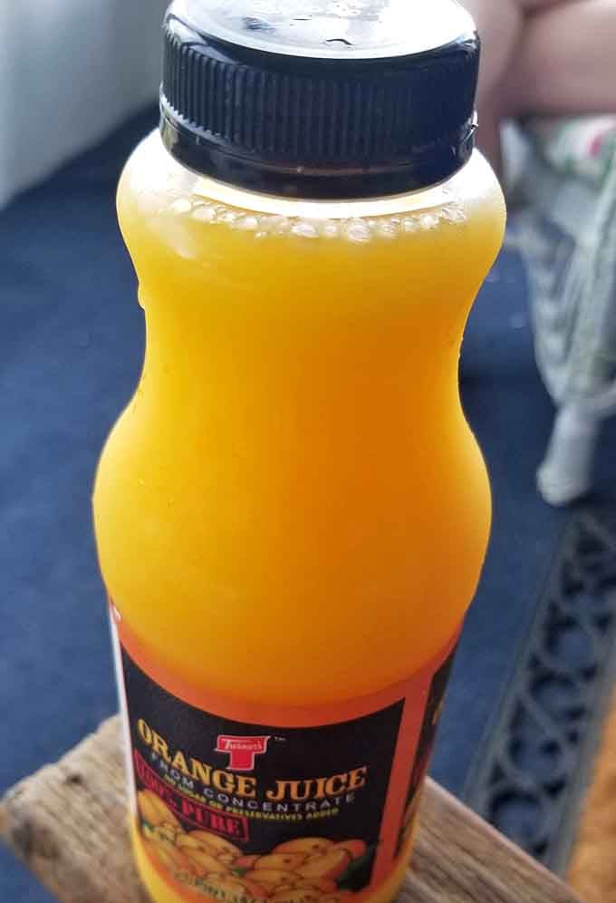 That orange juice bottle catches the light like liquid sunshine, the perfect companion to your carb-loaded adventure.