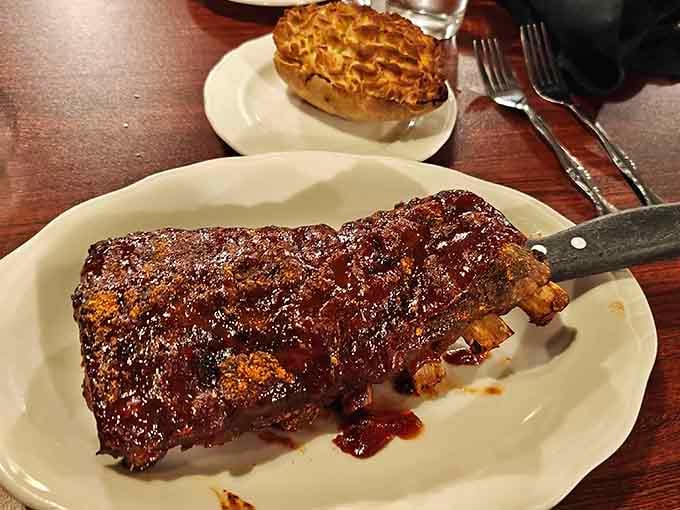 Those ribs wear their BBQ glaze like a badge of honor, promising fall-off-the-bone tenderness that'll have you licking your fingers shamelessly.
