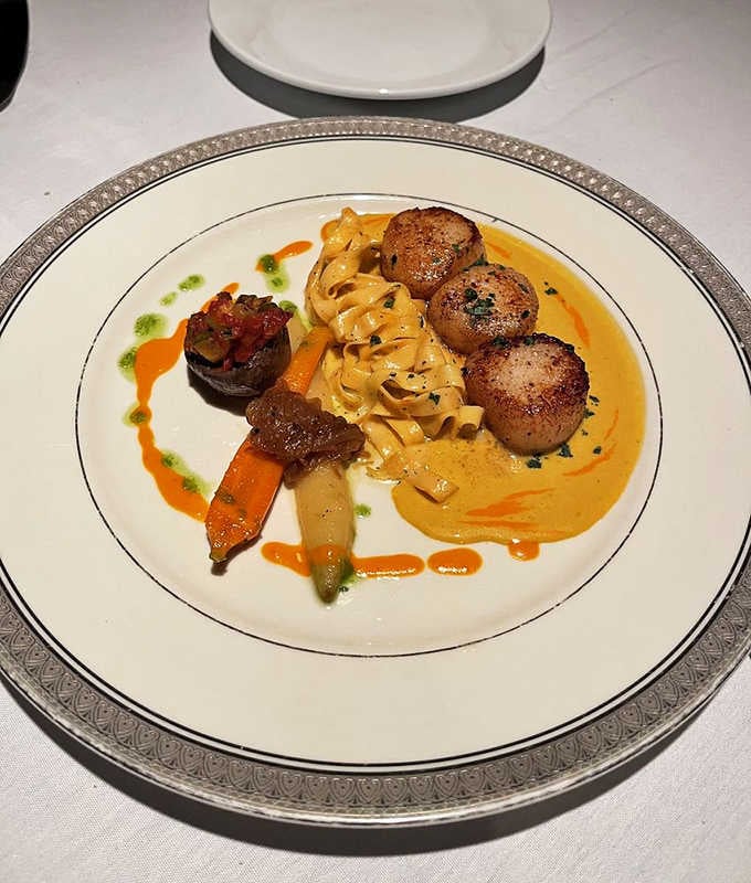 Pan-seared scallops with pasta that look like they swam straight from the ocean onto your plate this very morning.