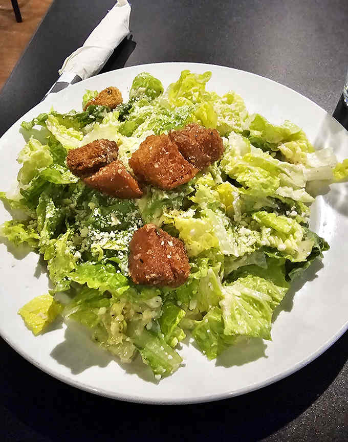 Fresh romaine, golden croutons, and parmesan prove that even salads get the royal treatment at this tavern.