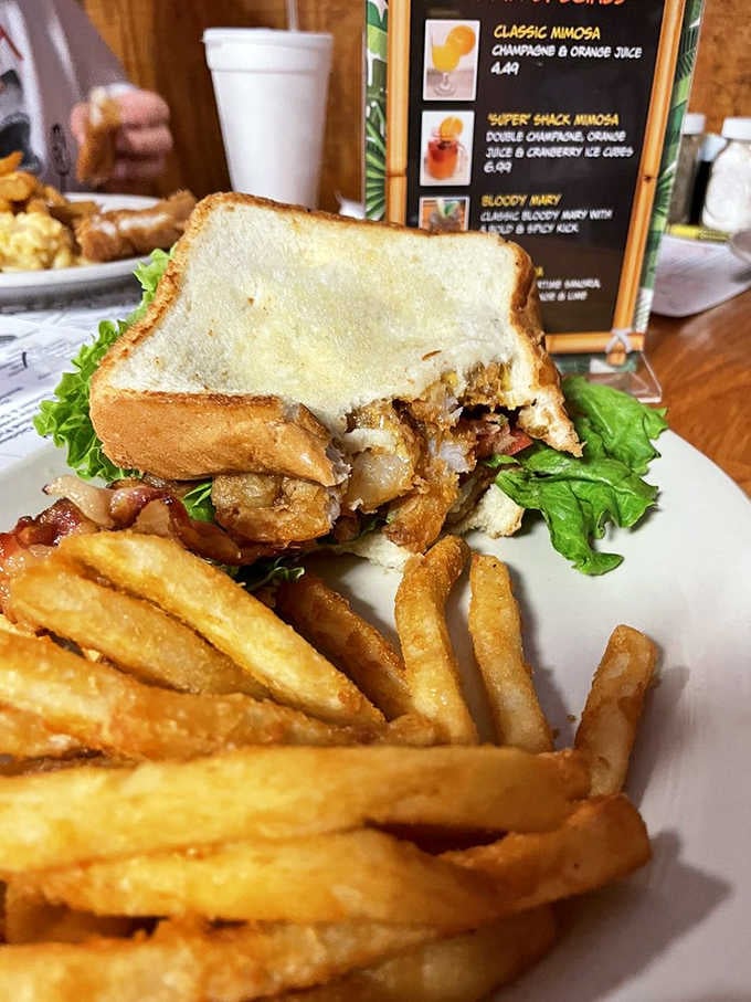 A shrimp BLT with golden fries is what happens when breakfast meets the ocean in the best way.