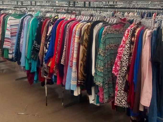 Colorful tops creating a rainbow effect that would make any wardrobe jealous of the variety hanging right here.