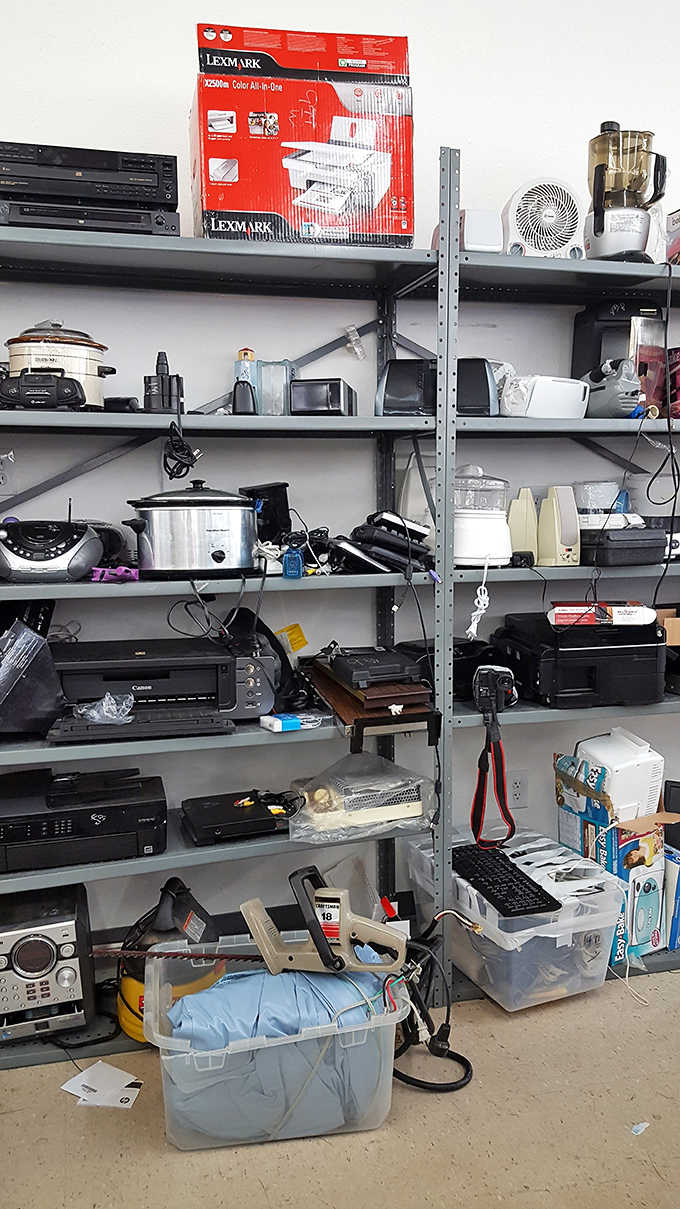 Electronics and small appliances lined up like a garage sale that got really, really organized overnight.