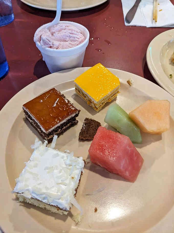 Dessert variety that includes fresh fruit for pretending you're being healthy and cakes for embracing sweet reality.