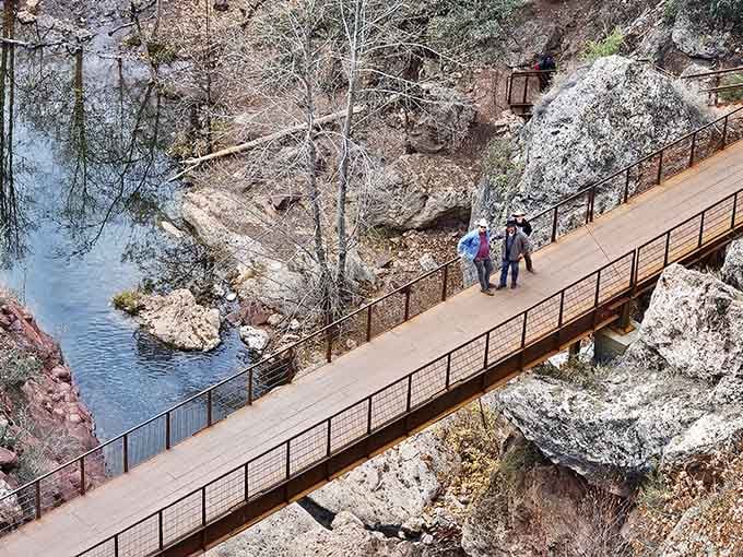 The wooden bridge spans crystal waters, offering front-row seats to one of Arizona's most underrated natural wonders.