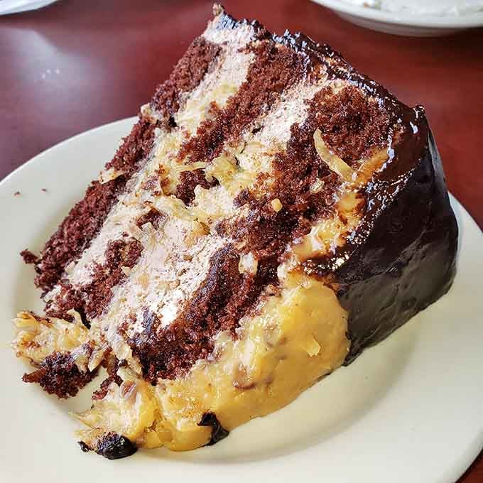 Chocolate layer cake with caramel drizzle is what happens when dessert decides to show off a little bit.