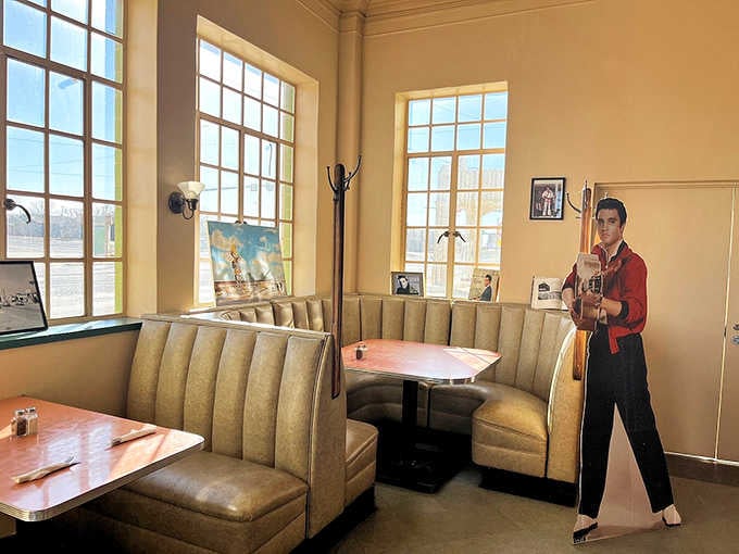 Vintage booths with pink Formica tables where Elvis cutouts keep watch over your meal like the King never left.