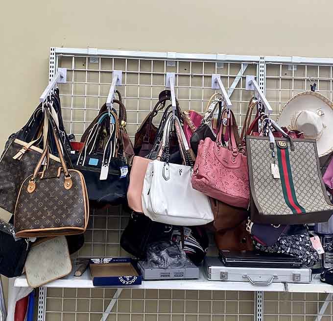 Designer bags hanging like art in a gallery, except these masterpieces won't drain your retirement fund.