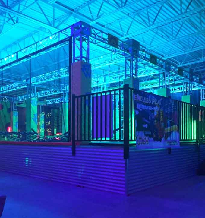 The ninja warrior course bathed in electric blue, where everyone gets to feel like an action hero.