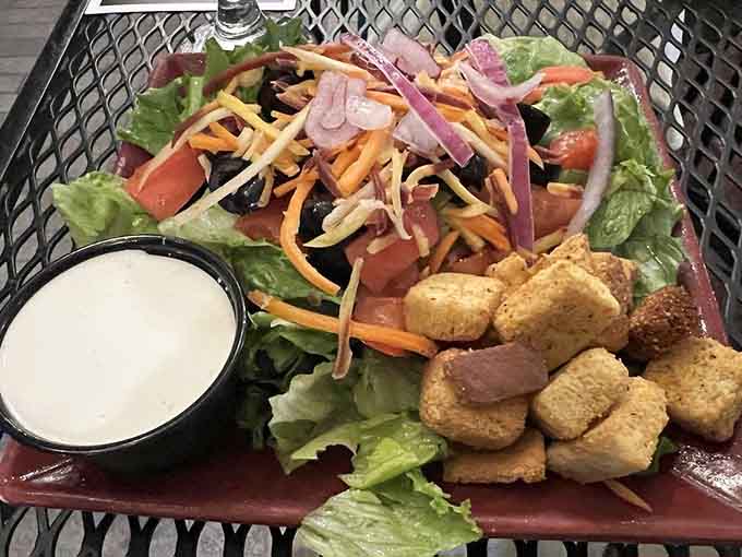 Fresh salad with croutons that haven't given up on life, plus dressing that actually tastes intentional.