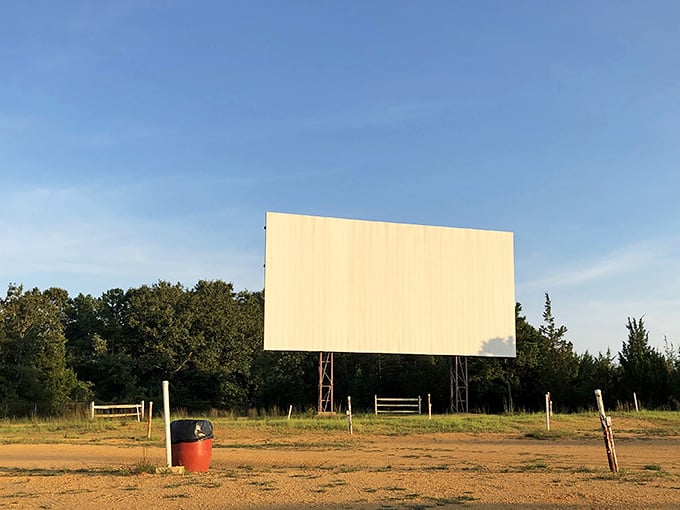 That drive-in screen is a nostalgic reminder that some experiences are better enjoyed from your car seat.