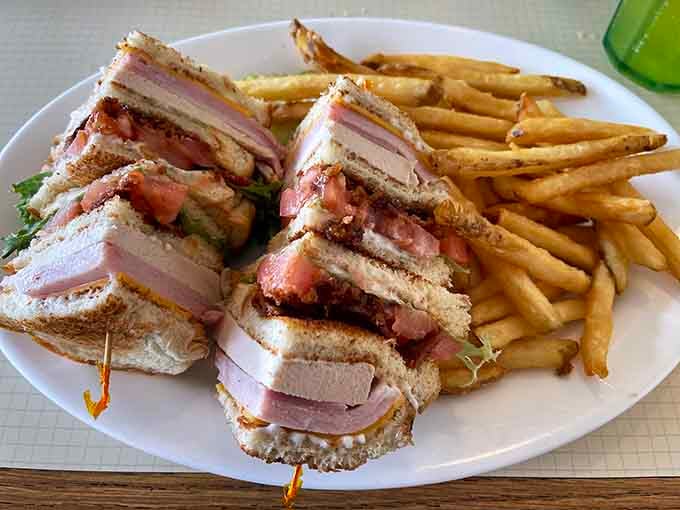 This triple-decker club sandwich is an architectural marvel of turkey, bacon, and tomato that requires both hands and commitment.