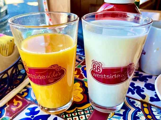 Fresh orange juice and cold milk in branded glasses, because even the simple things deserve proper presentation here.