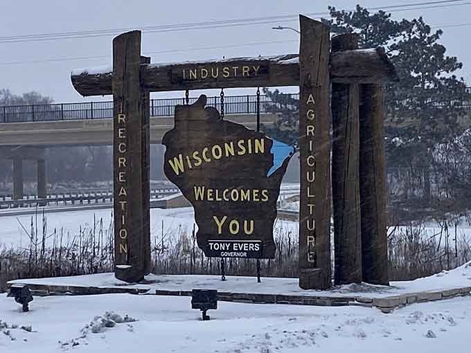 Winter transforms the welcome sign into a frosted greeting card, proving beauty exists in every season here.