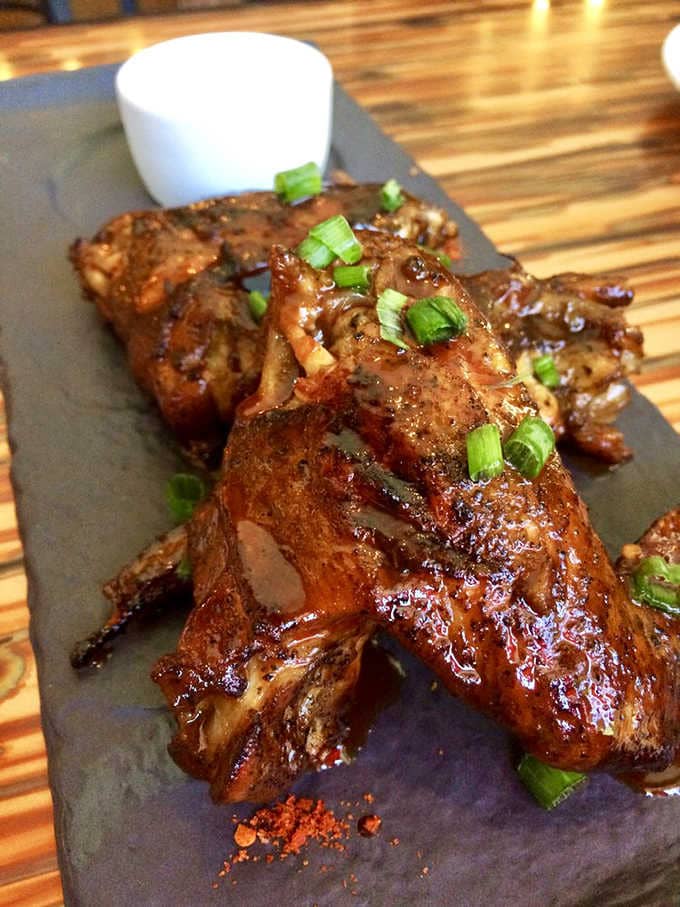 Glazed chicken wings that shine like they've been polished, ready to disappear faster than your diet resolutions.