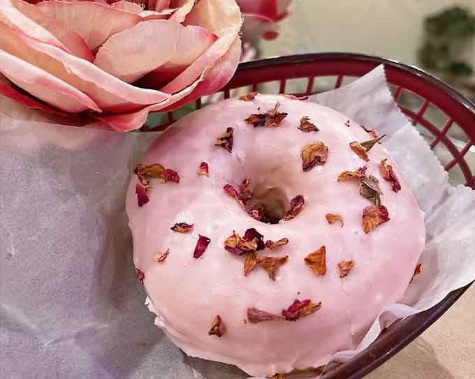 Delicate rose petals on pink icing transform an ordinary donut into something Instagram-worthy and absolutely delicious to boot.