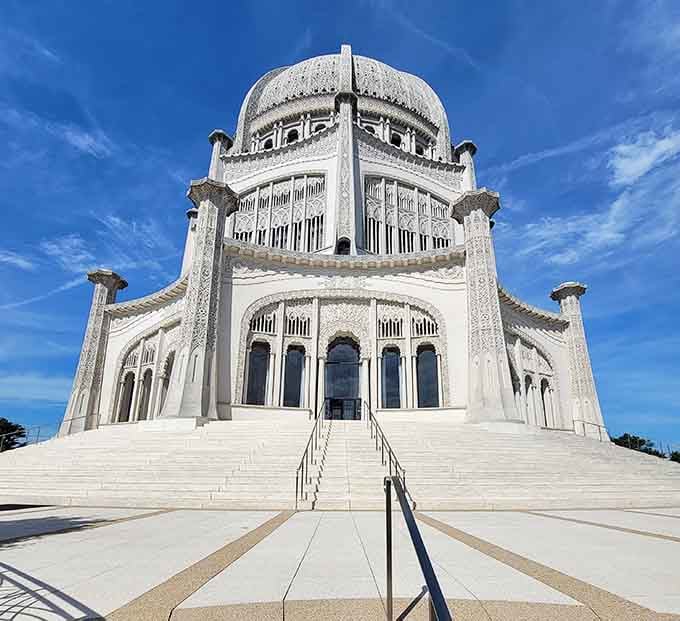 White stone and intricate lacework rise toward blue sky in this architectural masterpiece of spiritual beauty.