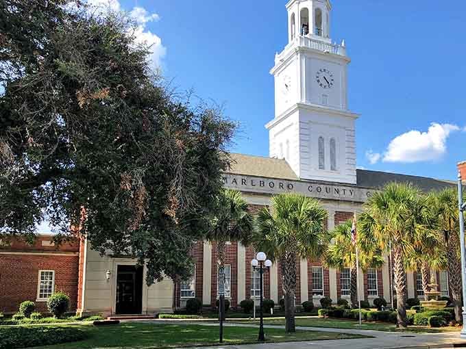 The white clock tower rises gracefully above palm trees, blending Southern charm with coastal elegance perfectly.