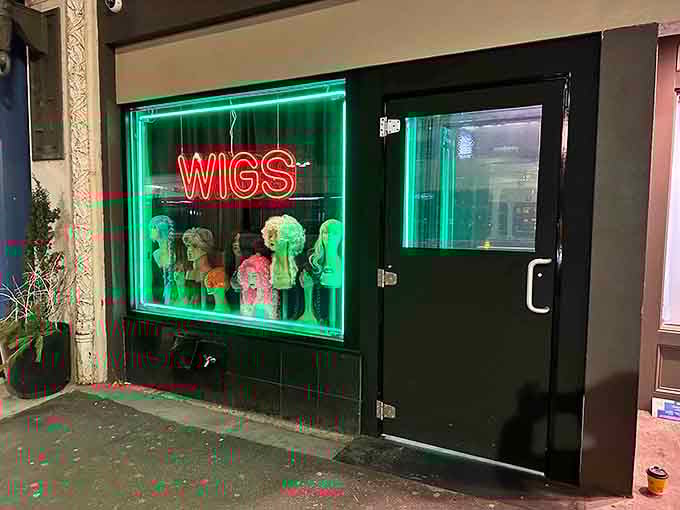 That neon "WIGS" sign glows like a beacon, marking the quirky entrance to Bogie's tiny steakhouse treasure below.
