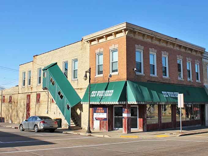 Green awnings shade storefronts on this classic downtown block where time moves at a more civilized pace.