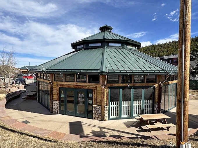 The charming round building with its distinctive green roof houses hand-carved carousel animals waiting for riders.