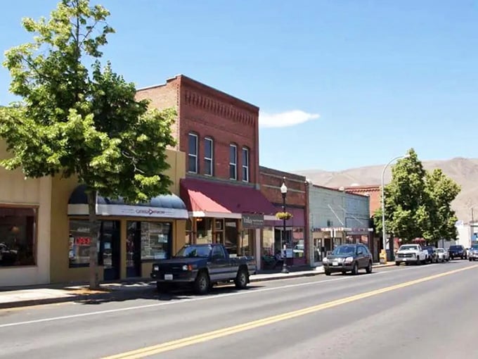 Mountains frame this main street like a postcard, where brick storefronts have weathered decades of changing times.