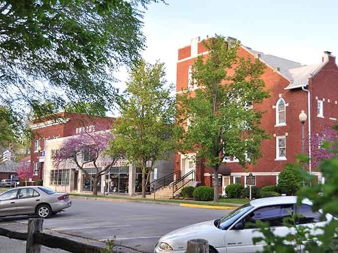 Flowering trees frame Corydon's historic brick buildings in nature's own purple and pink celebration.