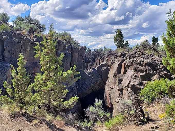 Jagged volcanic walls plunge deep into the earth, forming a natural corridor that looks like the planet cracked open wide.