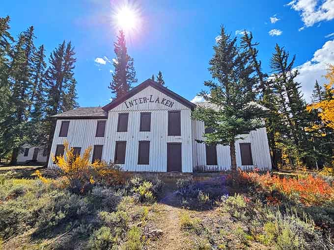This weathered resort building stands silent among autumn colors, its white facade a ghost of Colorado's glamorous past.