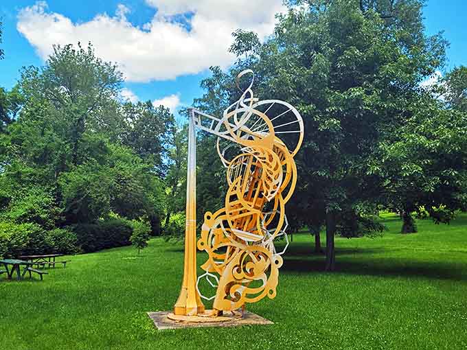 Bright orange swirls dance upward in this kinetic-looking sculpture, frozen motion that seems ready to spin at any moment.