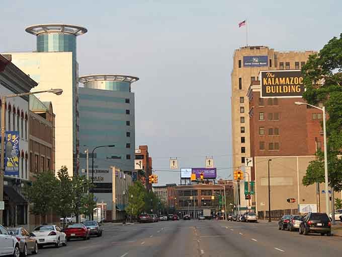 The Kalamazoo Building sign glows against evening sky, a beacon reminding everyone that some landmarks earn their iconic status honestly.