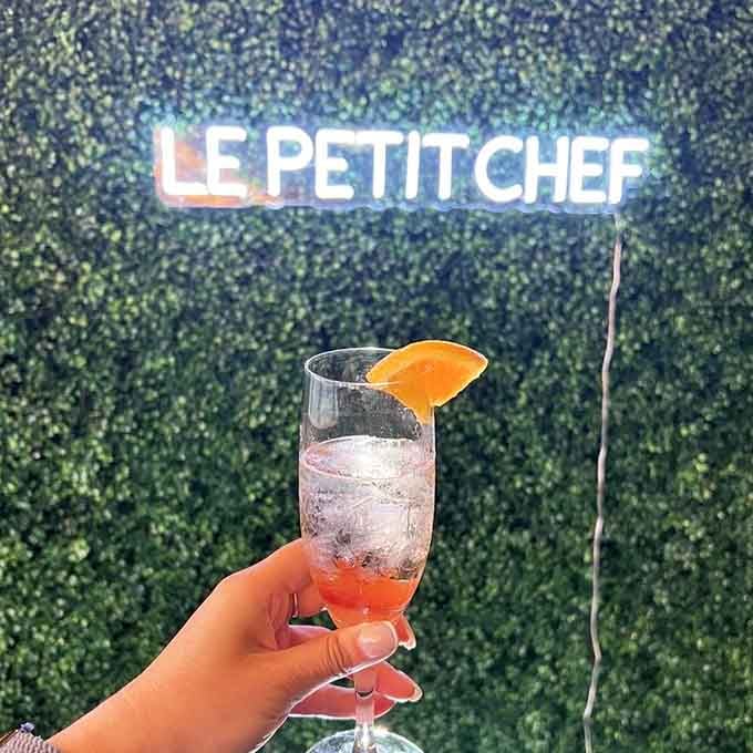 That citrus-garnished cocktail against the greenery wall promises an evening where technology meets taste in the most delightful way.