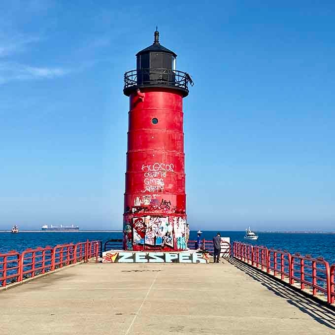 That bright red paint job makes this pierhead sentinel impossible to miss, like a fire engine parked permanently on the water.