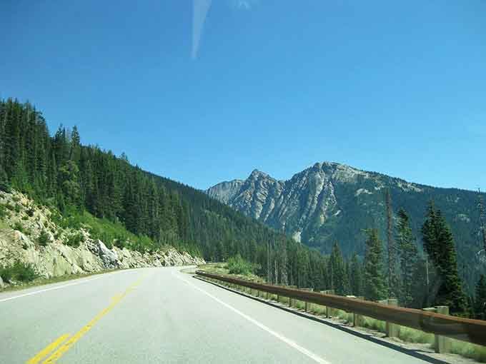 The open highway curves through peaks that'll make your heart skip like a teenager's first crush.