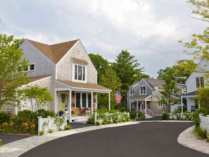 Fresh Cape Cod architecture with classic shingles and white trim proves new construction can honor timeless traditions.