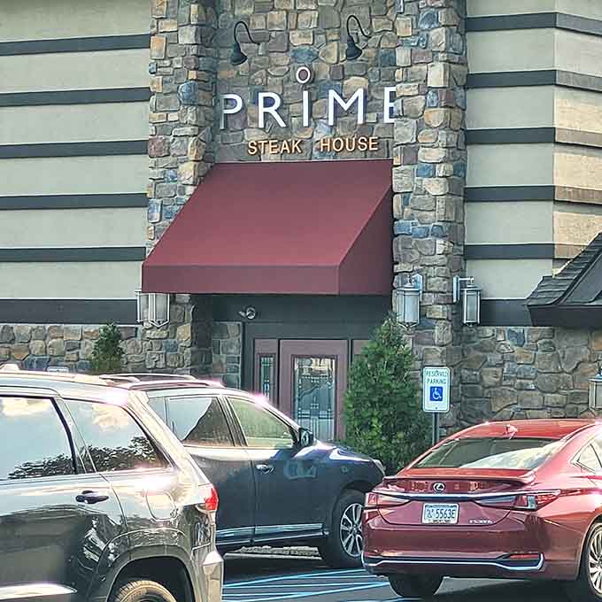 Stone facade with dramatic stripes creates an upscale entrance that promises quality beef awaits inside those doors.