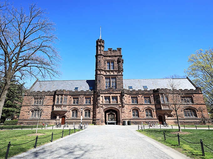 Imposing brownstone tower rises majestically against blue skies, its Gothic details rivaling anything you'd find at Oxford or Cambridge.