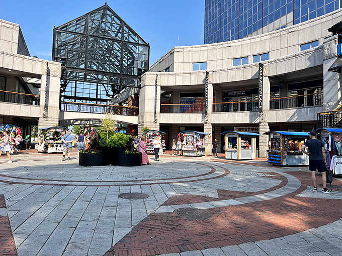 That distinctive glass pyramid entrance welcomes crowds into a bustling marketplace where food and history blend together perfectly under one roof.