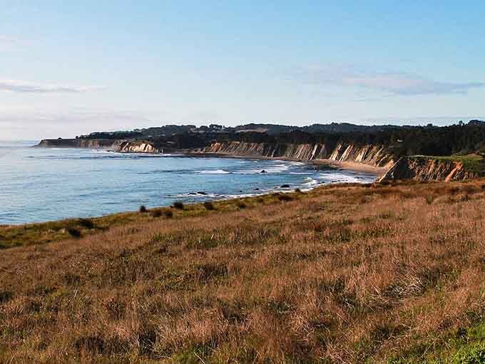 Golden cliffs meet endless ocean in a coastal scene that belongs on a postcard from paradise.