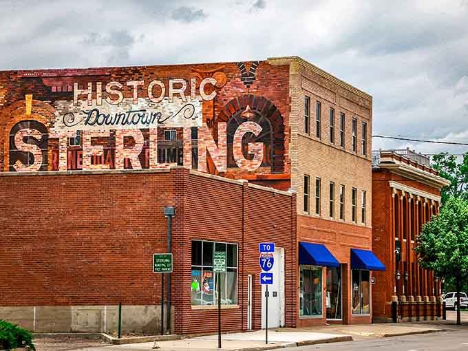 That bold mural celebrates downtown pride on weathered brick, turning ordinary walls into community conversation starters worth photographing.