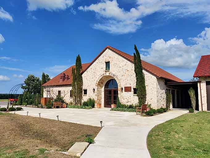 Cypress trees flanking stone archways welcome visitors like they're arriving at a genuine Tuscan wine estate.