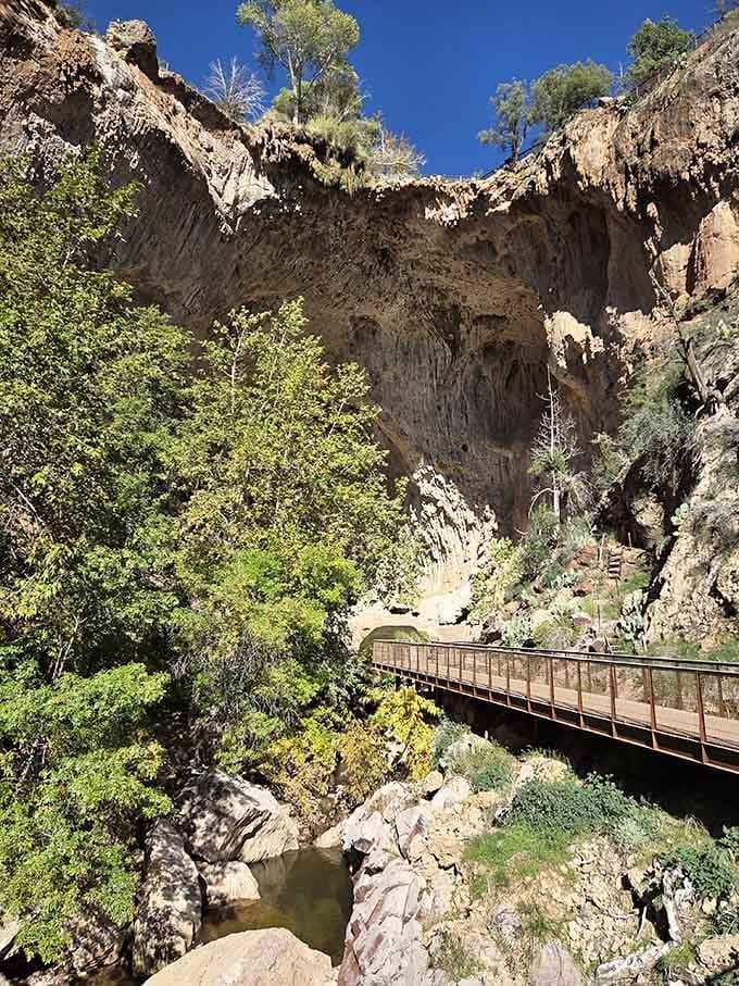 Walking beneath this natural bridge feels like entering a secret world carved by patient water and time.