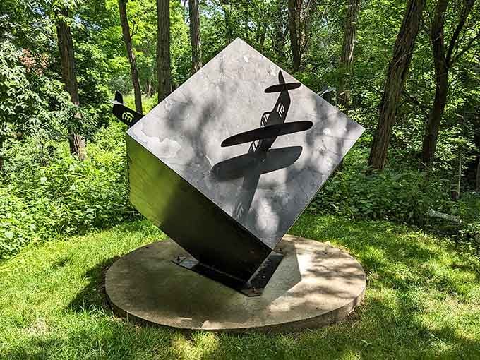 Bold black brushstrokes slash across polished metal, balancing Eastern calligraphy with modern sculptural form on a rotating base.