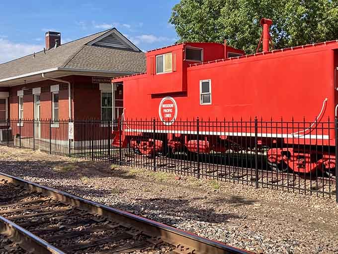 That bright red caboose catches your eye immediately, a cheerful reminder of when every train had one at the end.